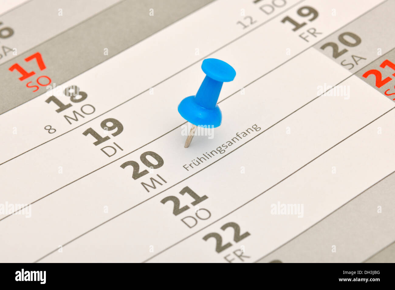 Calendar with a push pin marking "Fruehlingsanfang", German for the ...