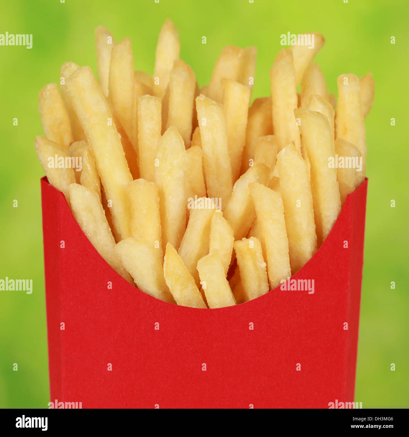 French fries in a red box over a green background Stock Photo - Alamy