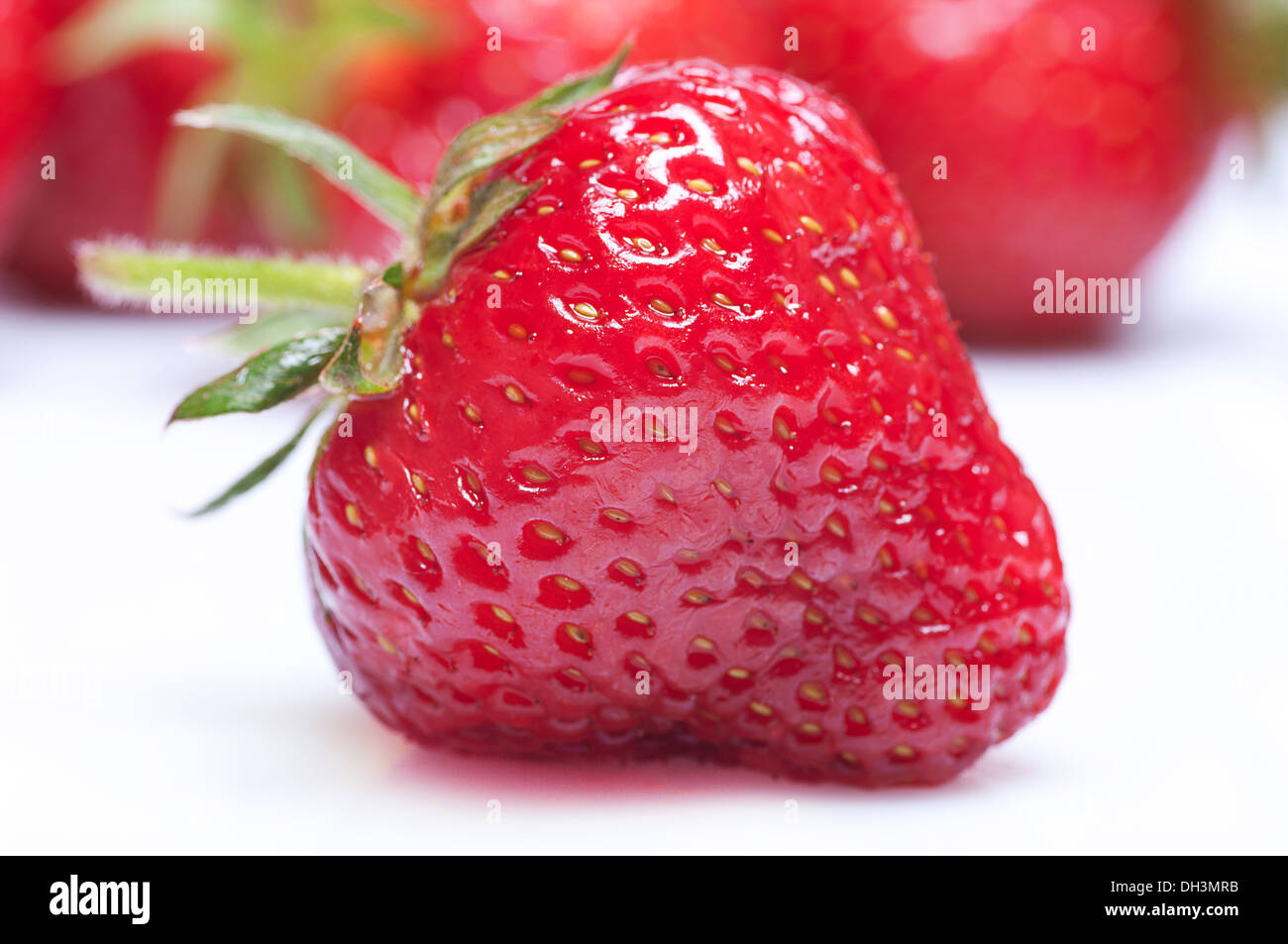 Strawberry with other strawberries Stock Photo - Alamy