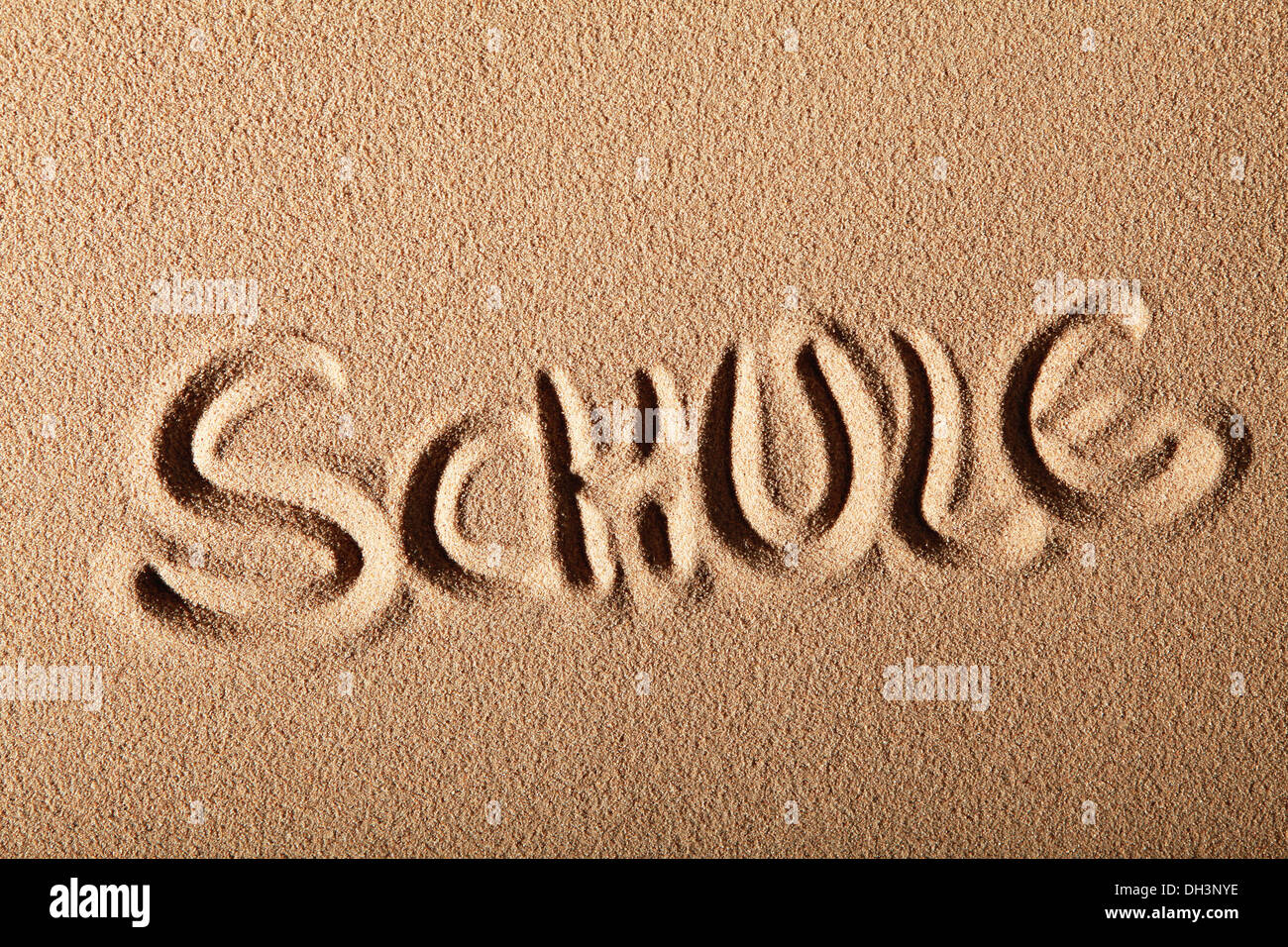 Writing in the sand "SCHULE" or "SCHOOL Stock Photo - Alamy