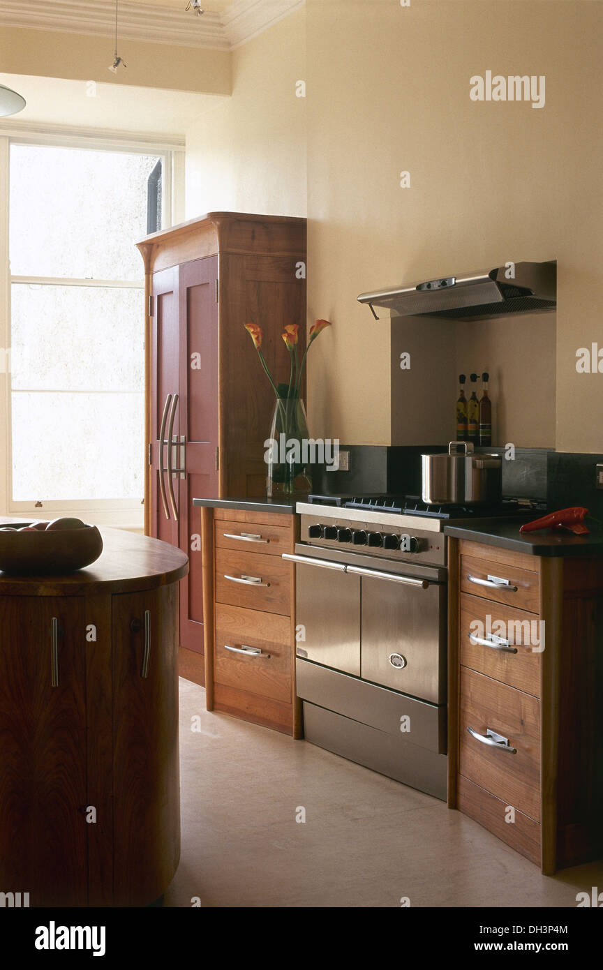 Stainless steel range oven in modern kitchen with polished wood fitted ...