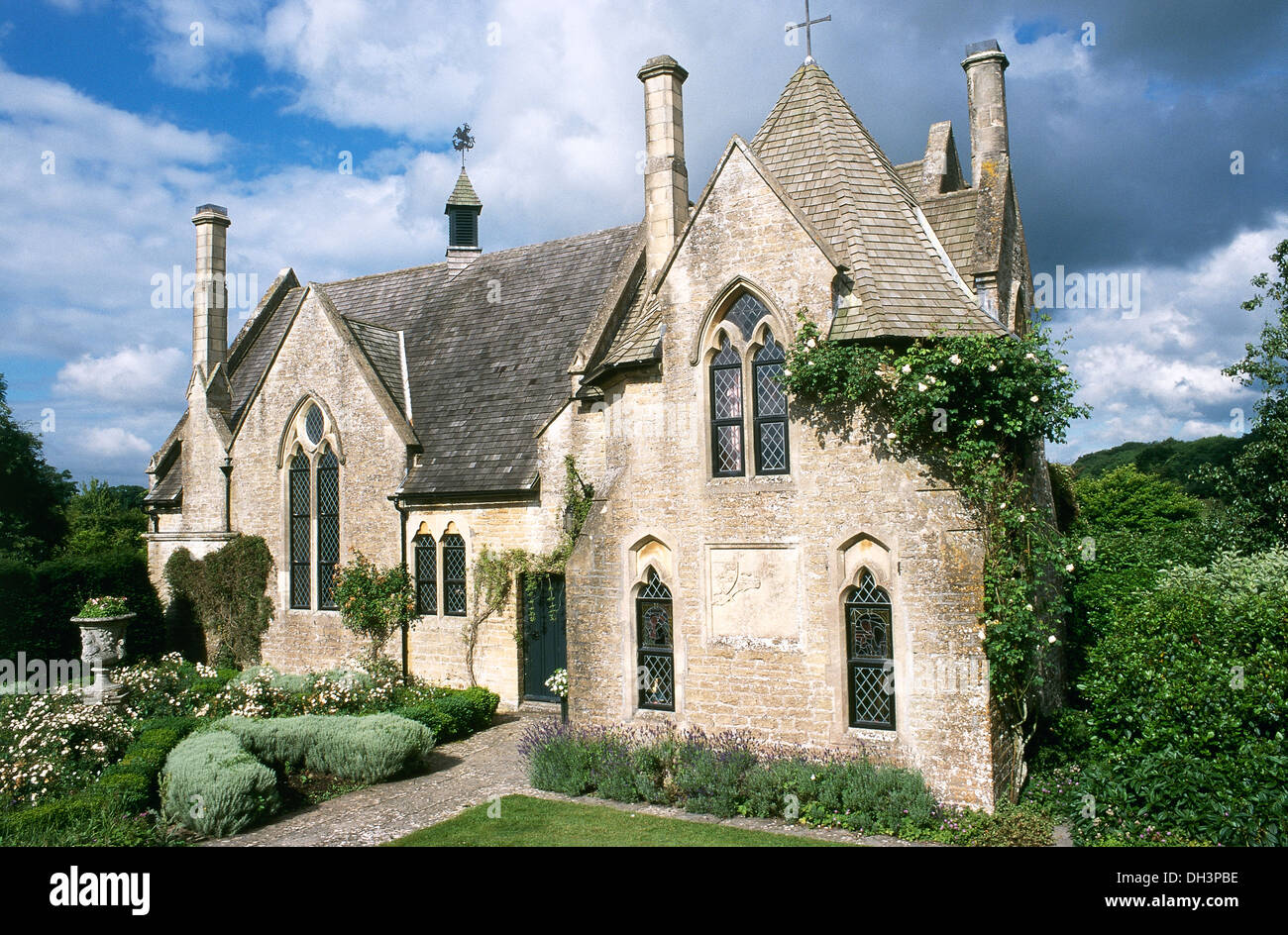 Exterior of a gothic stone house with arched leaded glass windows and ...