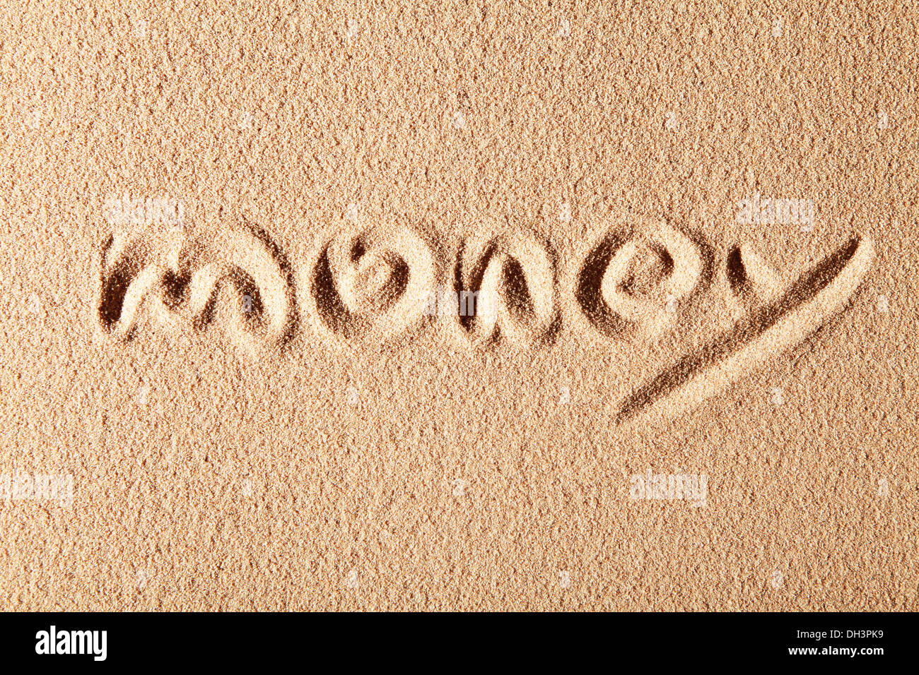 The word money, written in sand Stock Photo - Alamy