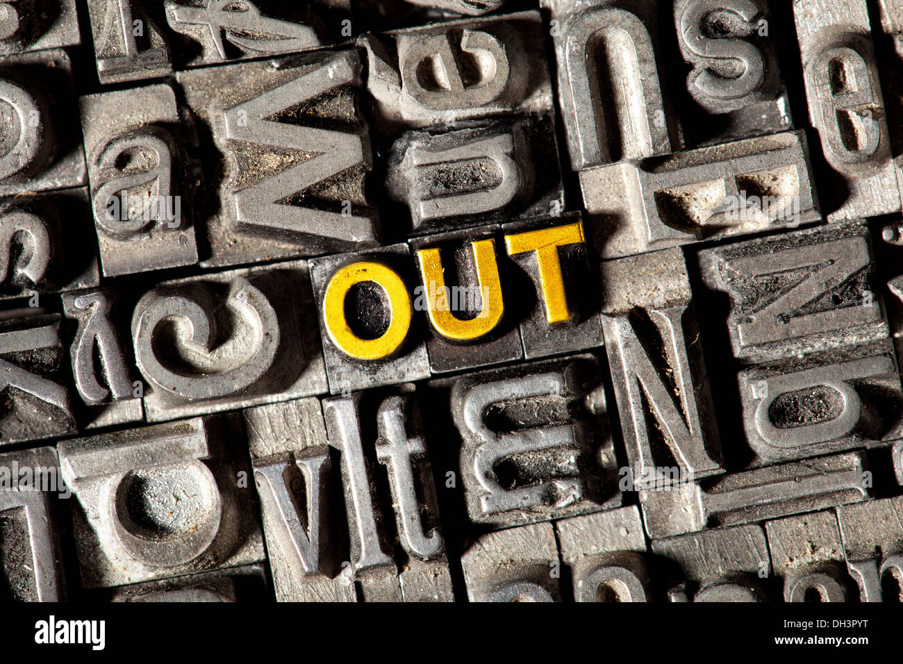 Old lead letters forming the word OUT Stock Photo - Alamy