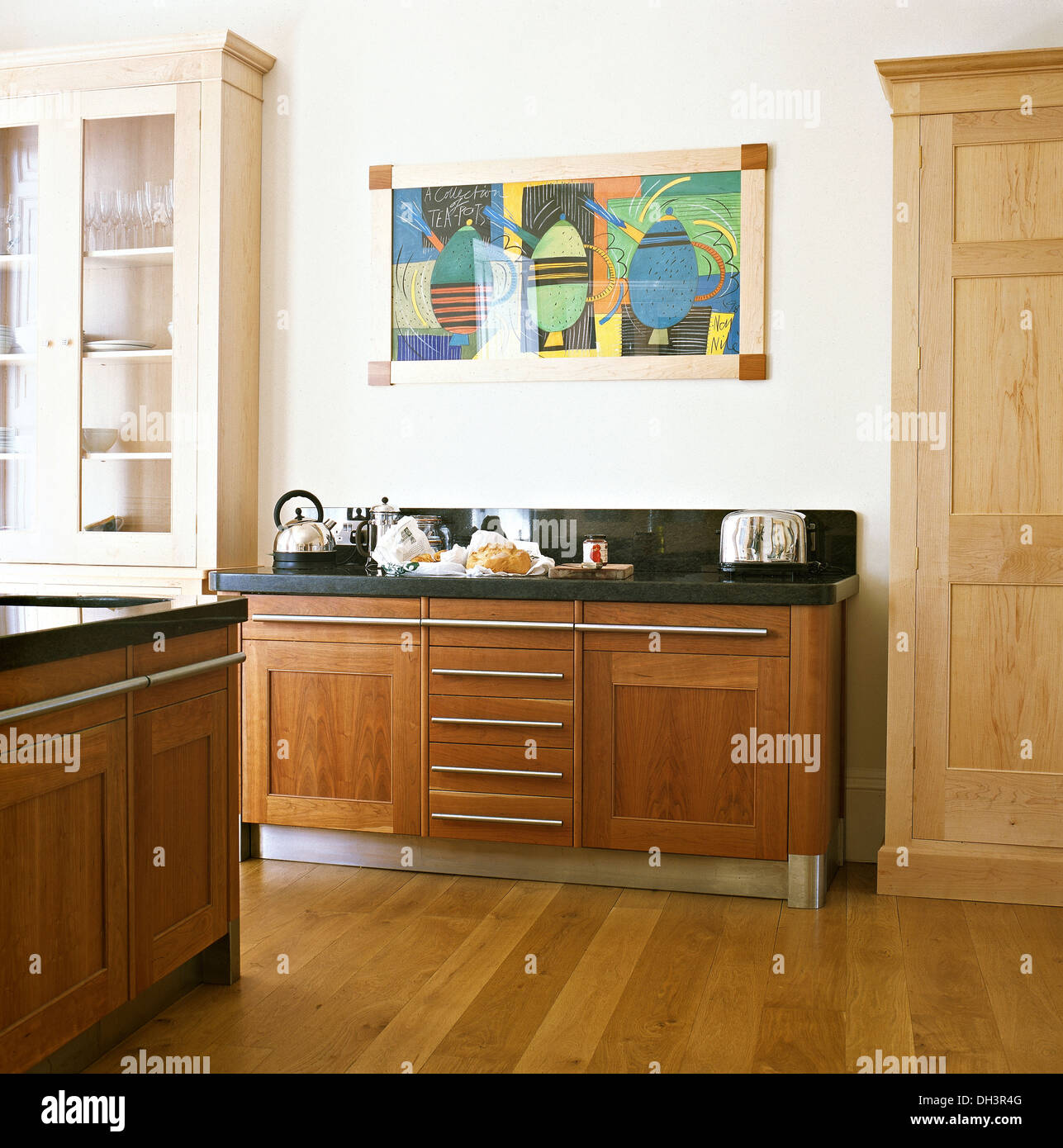 Large picture above granite topped fitted unit in modern kitchen with ...