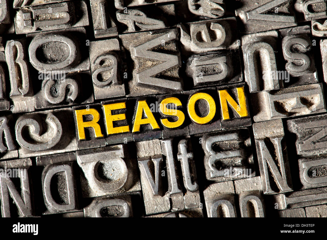 Old lead letters forming the word REASON Stock Photo - Alamy