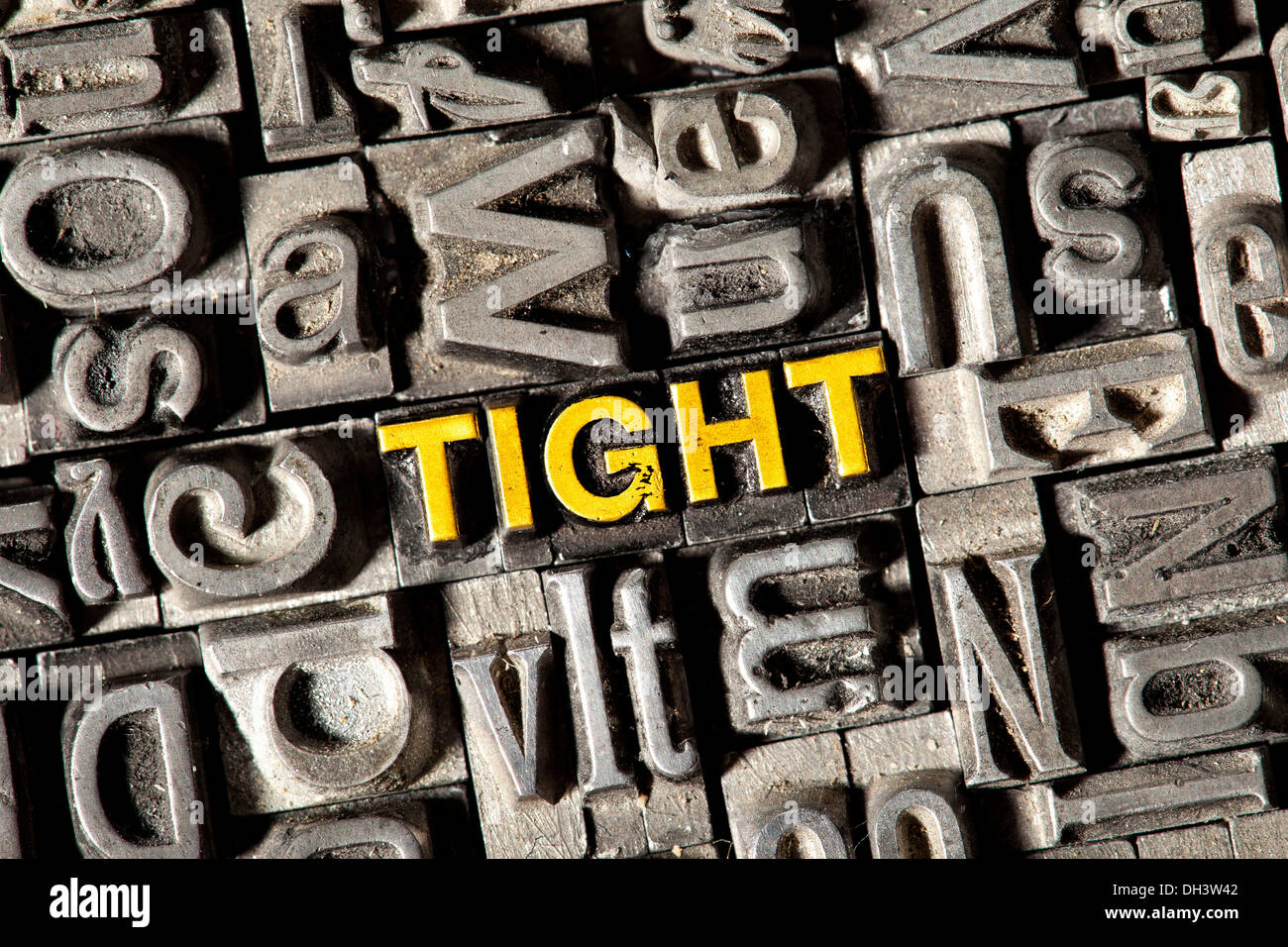 Old lead letters forming the word "TIGHT Stock Photo - Alamy