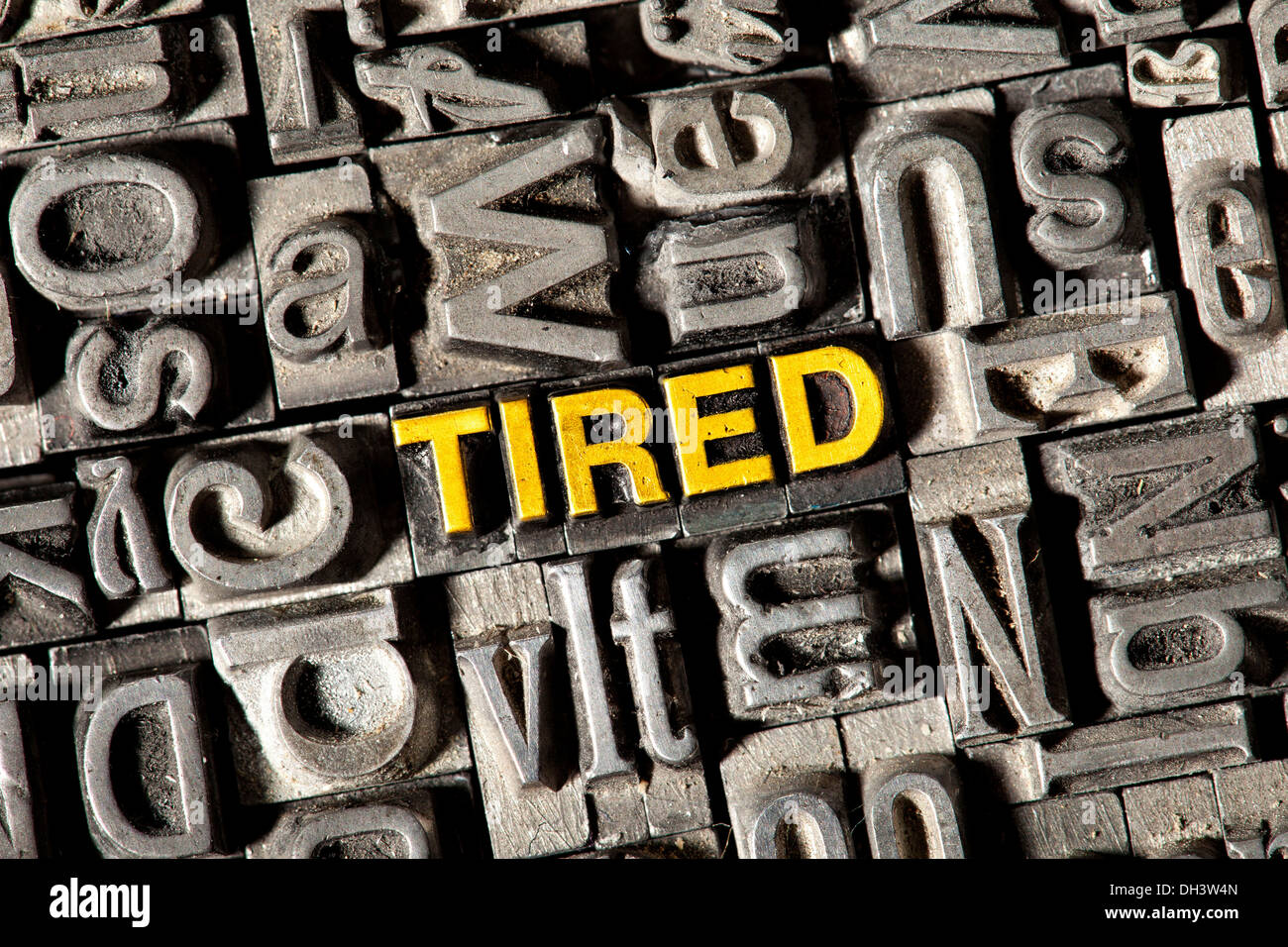 Old lead letters forming the word "TIRED Stock Photo - Alamy