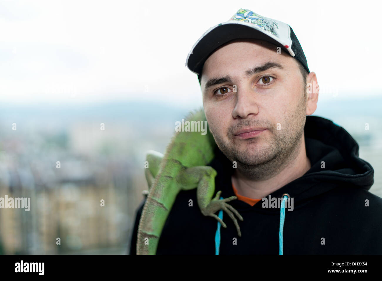 portrait of the young man with the iguana Stock Photo - Alamy