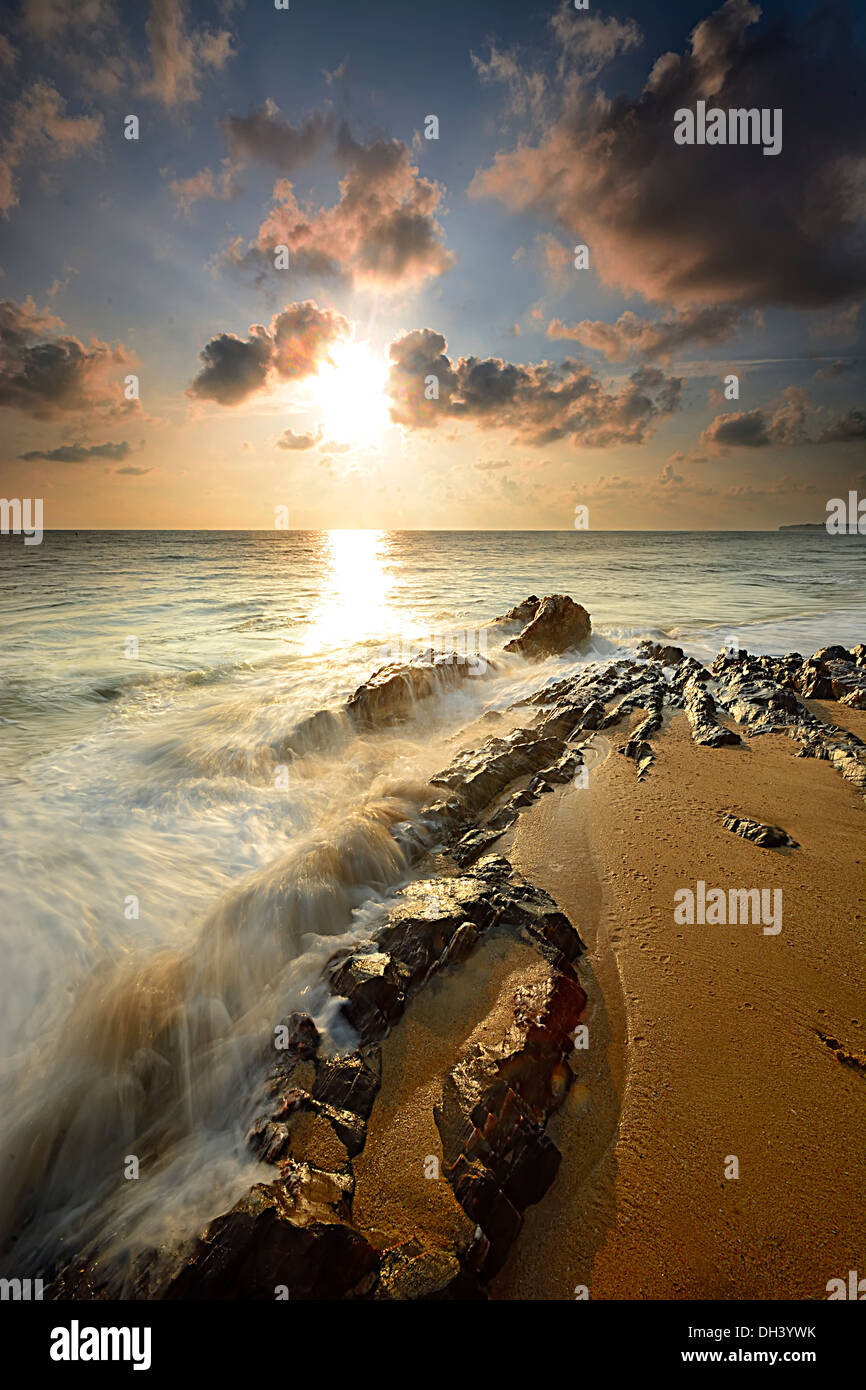 Sea waves lash line impact rock on the beach Stock Photo - Alamy