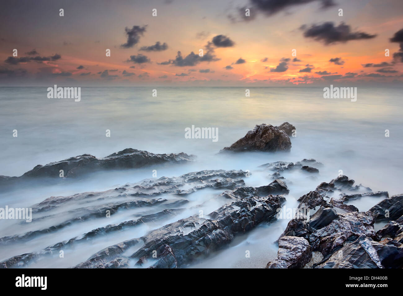Sea waves lash line impact rock on the beach Stock Photo - Alamy