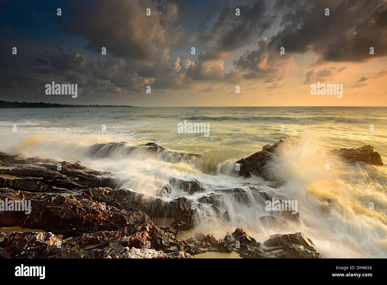 Sea waves lash line impact rock on the beach Stock Photo - Alamy