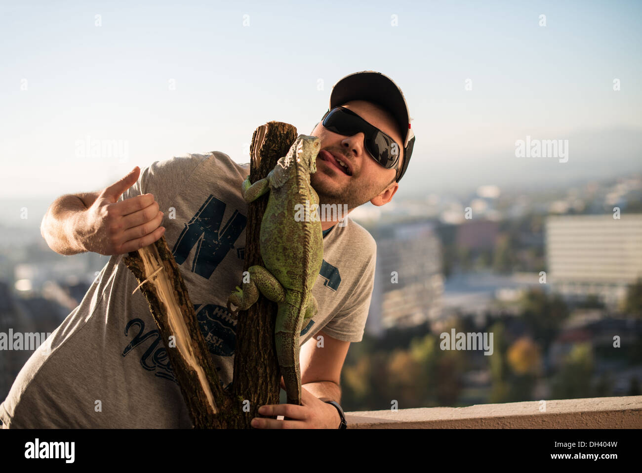 portrait of the young man with the iguana Stock Photo - Alamy