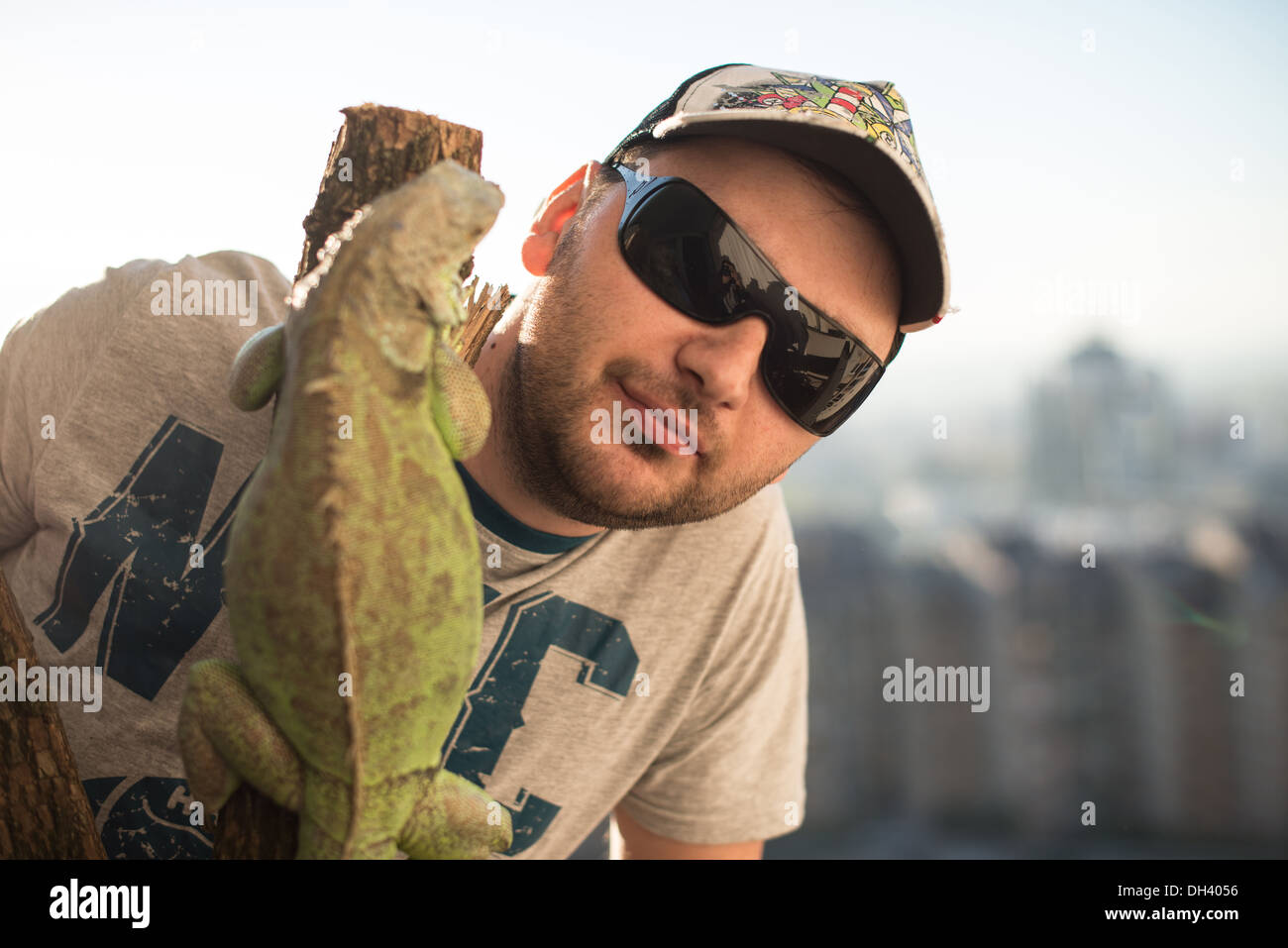 portrait of the young man with the iguana Stock Photo - Alamy