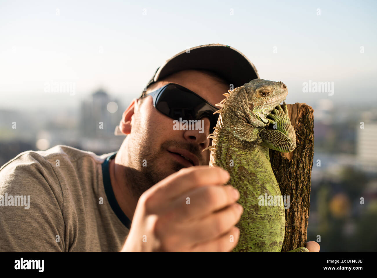 portrait of the young man with the iguana Stock Photo - Alamy