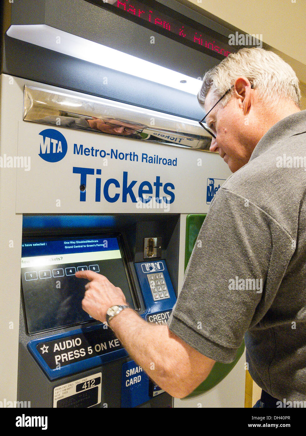 Man Purchasing Metro North Transit Train Tickets at Self Serve Vending ...