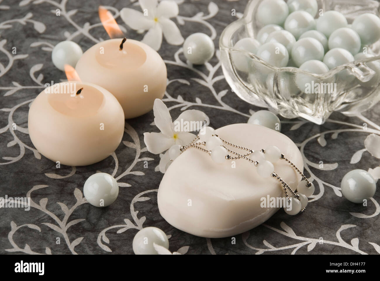 Close-up of a bar of soap with pearls and candles Stock Photo - Alamy