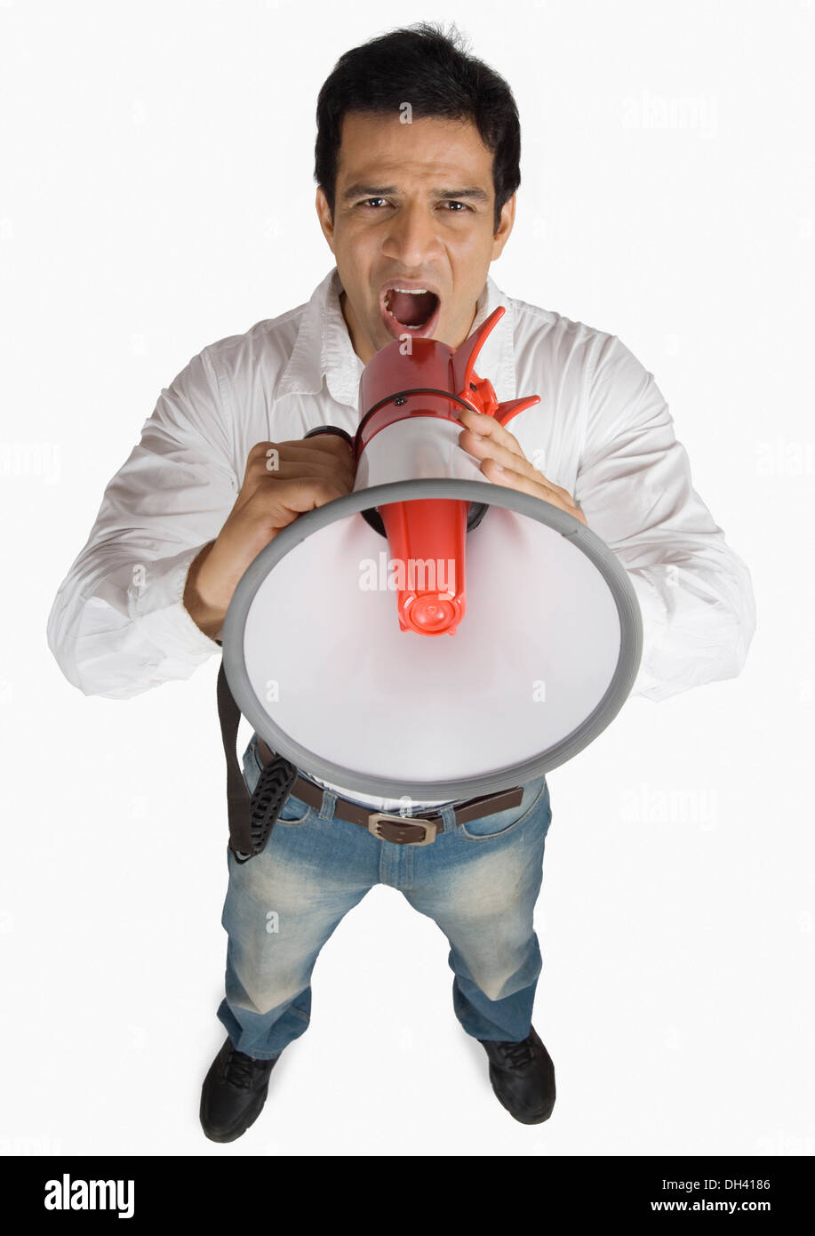 Portrait of a young man shouting into a megaphone Stock Photo - Alamy