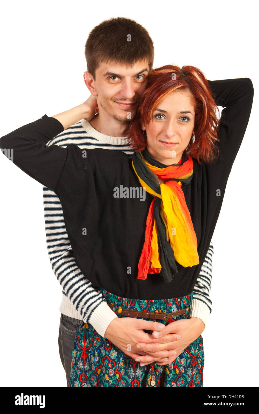 Happy young couple standing in embrace isolated on white background ...