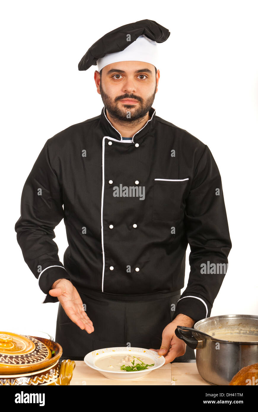 Chef man showing soup on plate in kitchen Stock Photo - Alamy