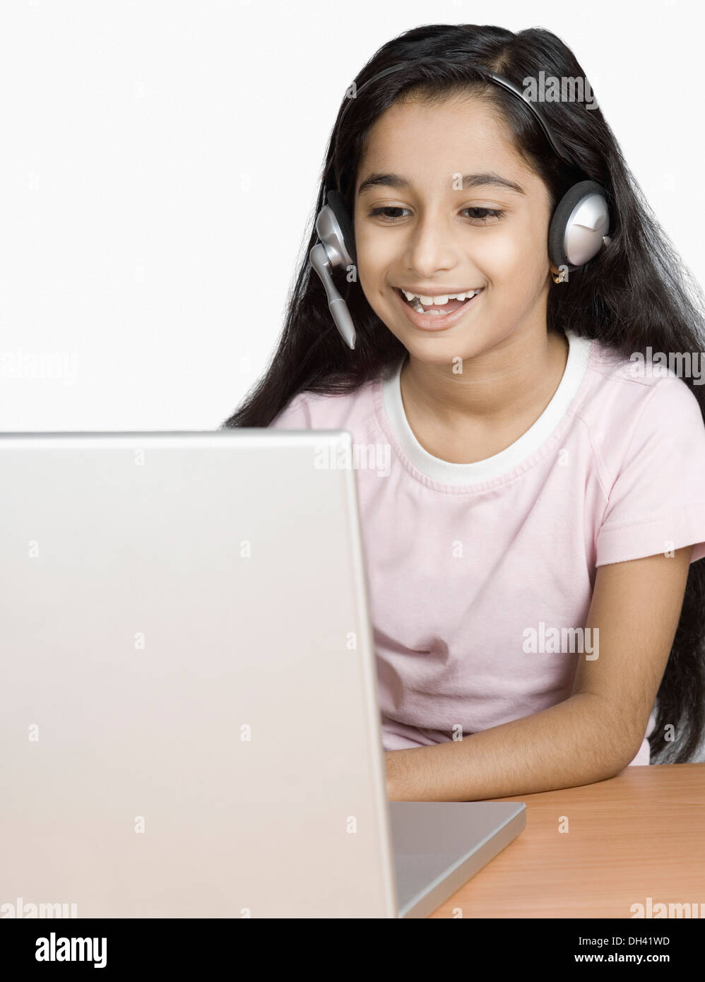Girl chatting online and smiling Stock Photo - Alamy