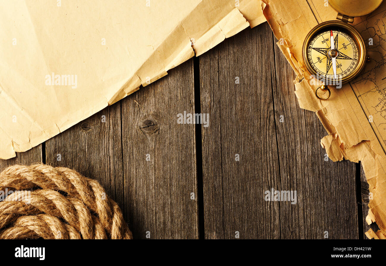 Antique compass and rope over old map Stock Photo - Alamy