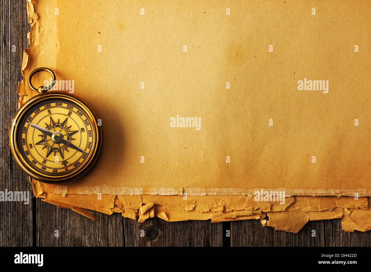 Antique brass compass over old background Stock Photo - Alamy