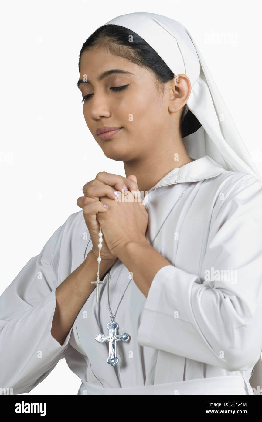 Close-up of a nun standing in the prayer position Stock Photo - Alamy