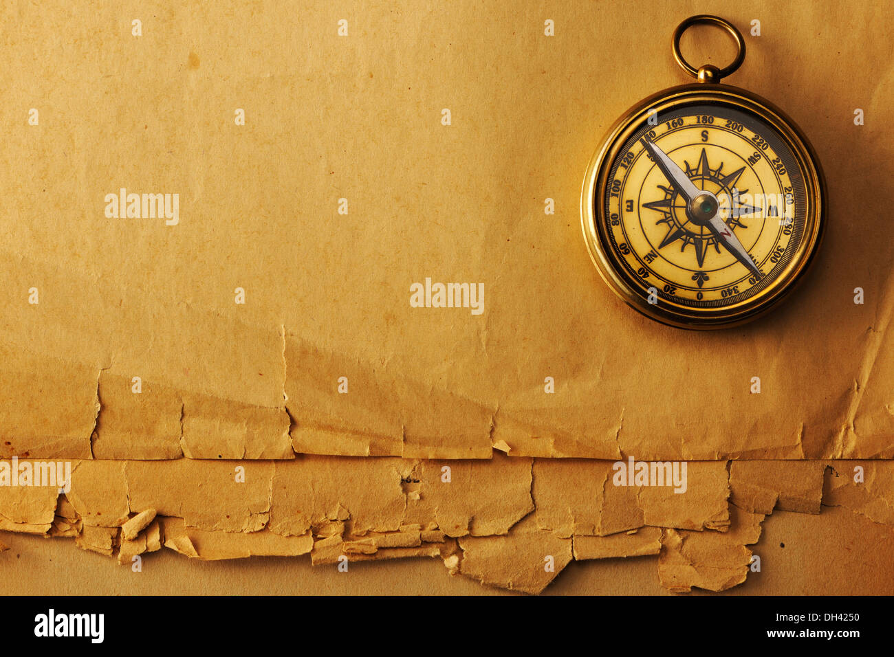Antique brass compass over old background Stock Photo - Alamy
