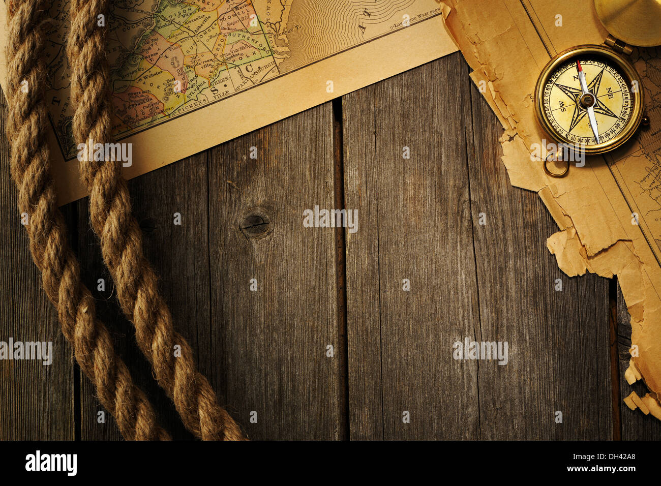 Antique compass and rope over old map Stock Photo - Alamy