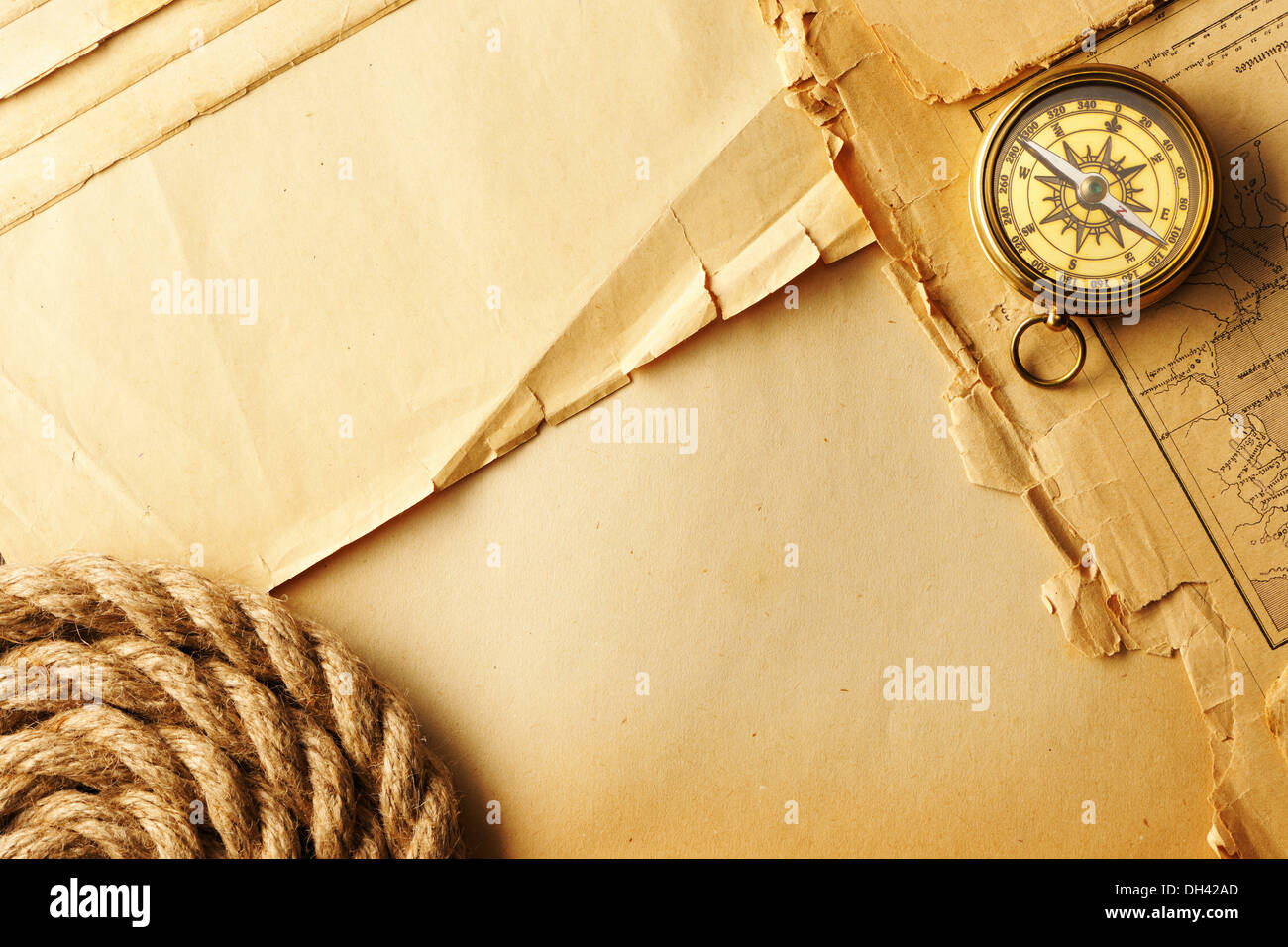 Antique compass and rope over old map Stock Photo - Alamy