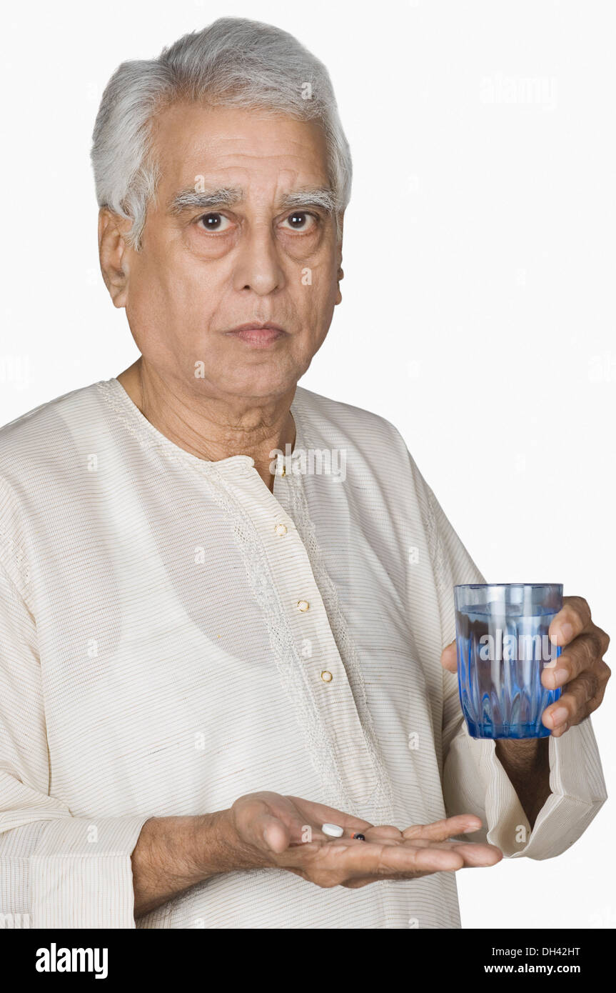 Portrait of a senior man taking medicine Stock Photo - Alamy