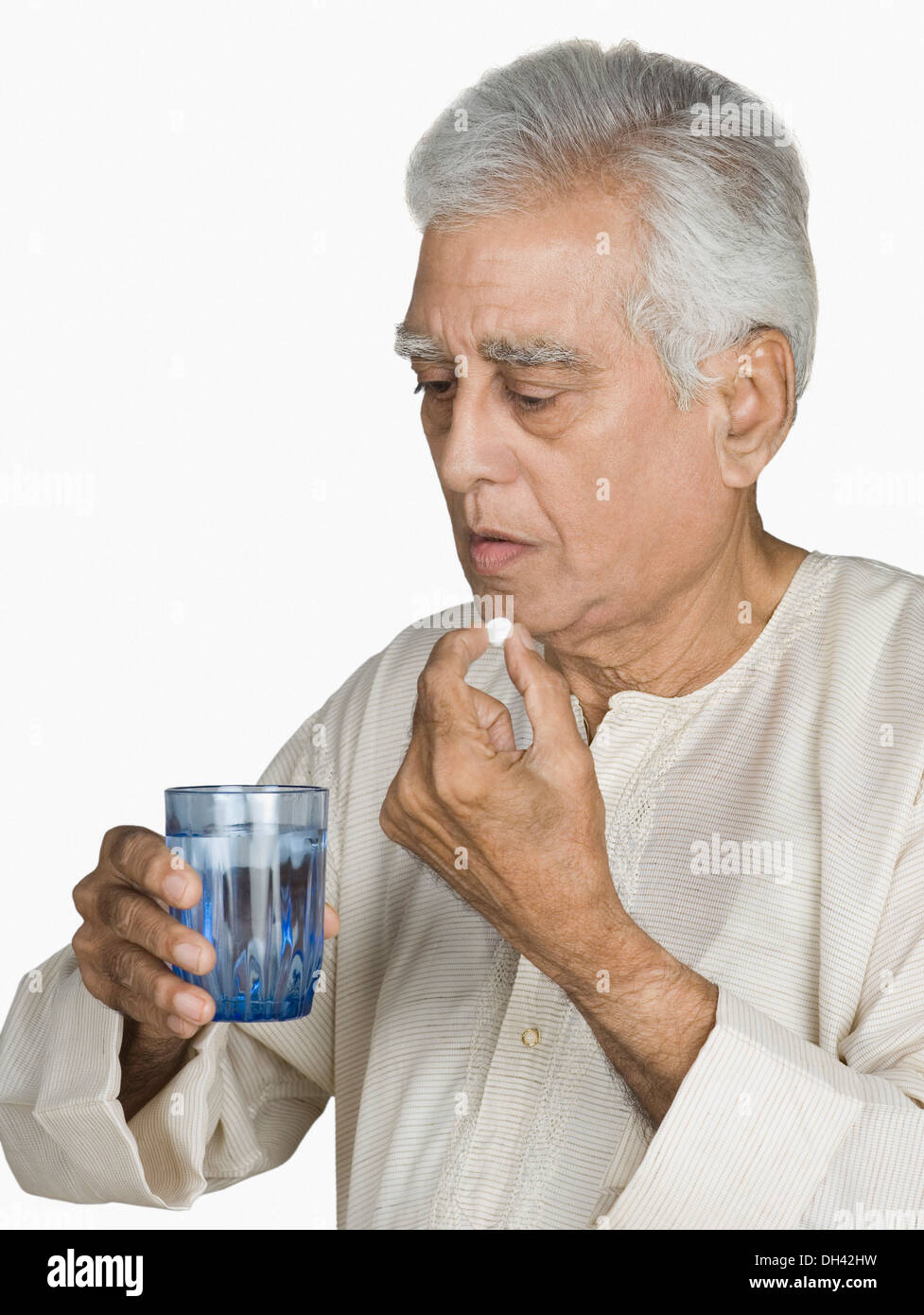 Indian old man taking medicine hi-res stock photography and images - Alamy