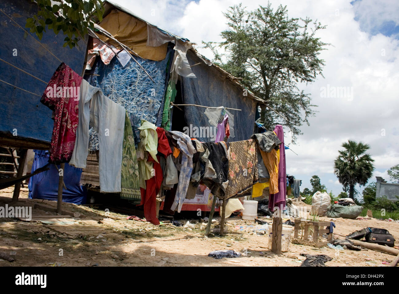 Laundry is drying near plastic and wood homes in a neighborhood near a ...