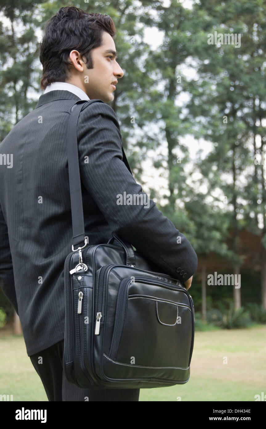 Businessman carrying a briefcase Stock Photo - Alamy