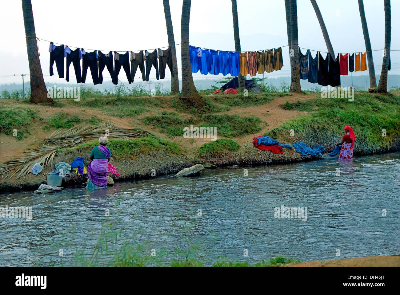 women washing clothes in river and hanging to dry Rural Dhobi ghat at ...