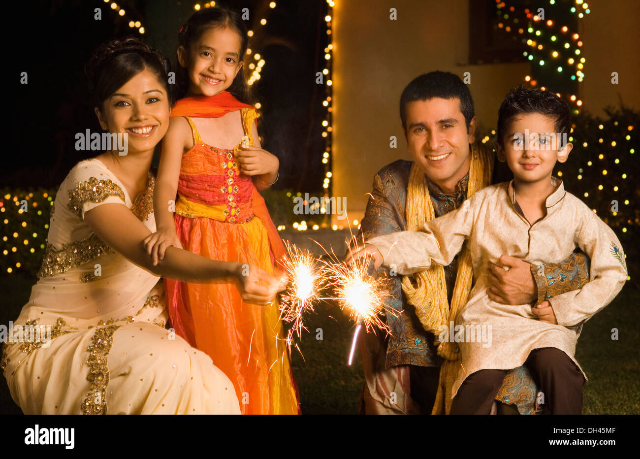 Family celebrating diwali Stock Photo - Alamy