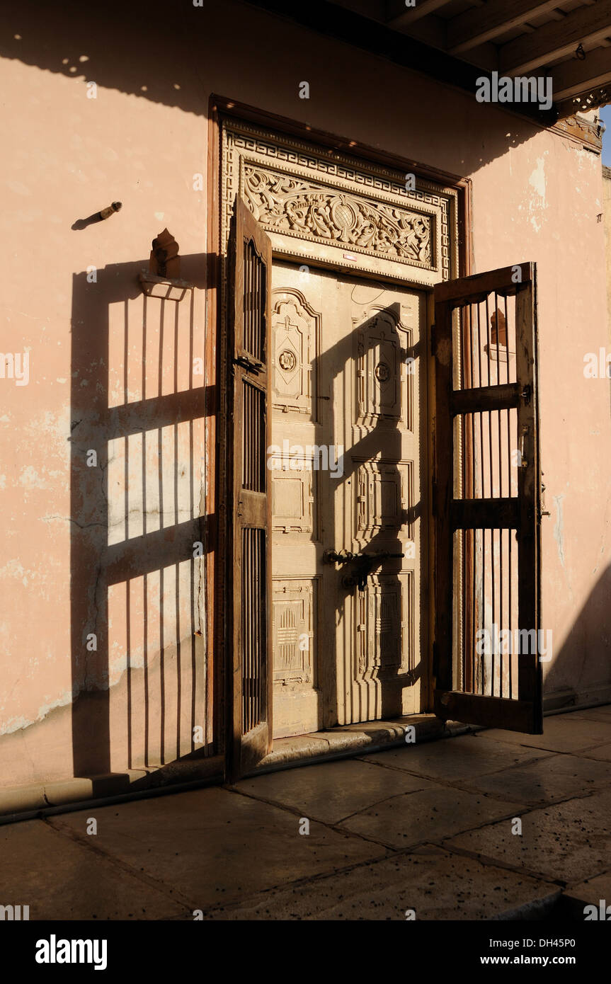Open door shadow on closed door of old village house , Gujarat , India ...