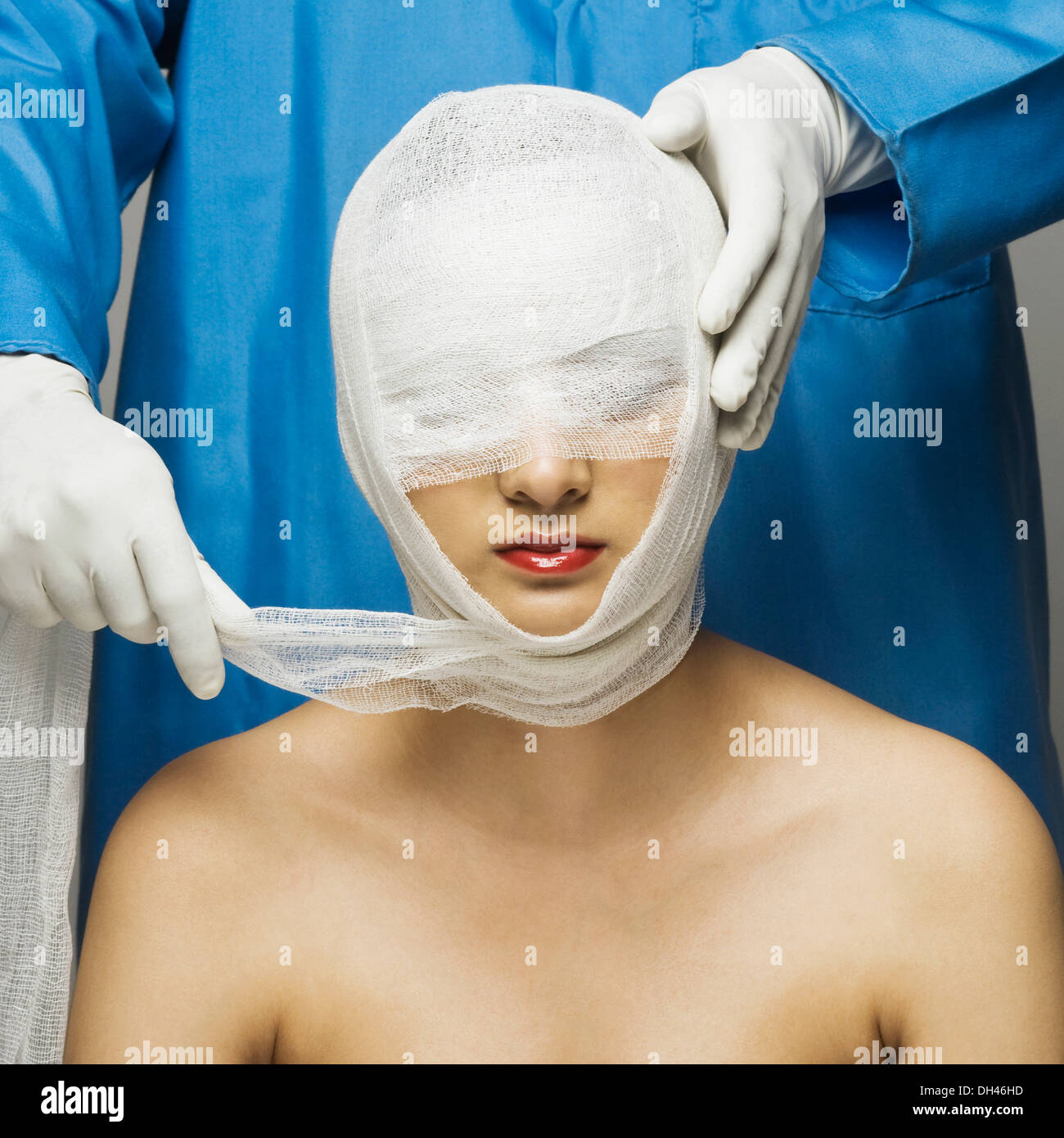 Surgeon wrapping bandage on woman's face Stock Photo - Alamy