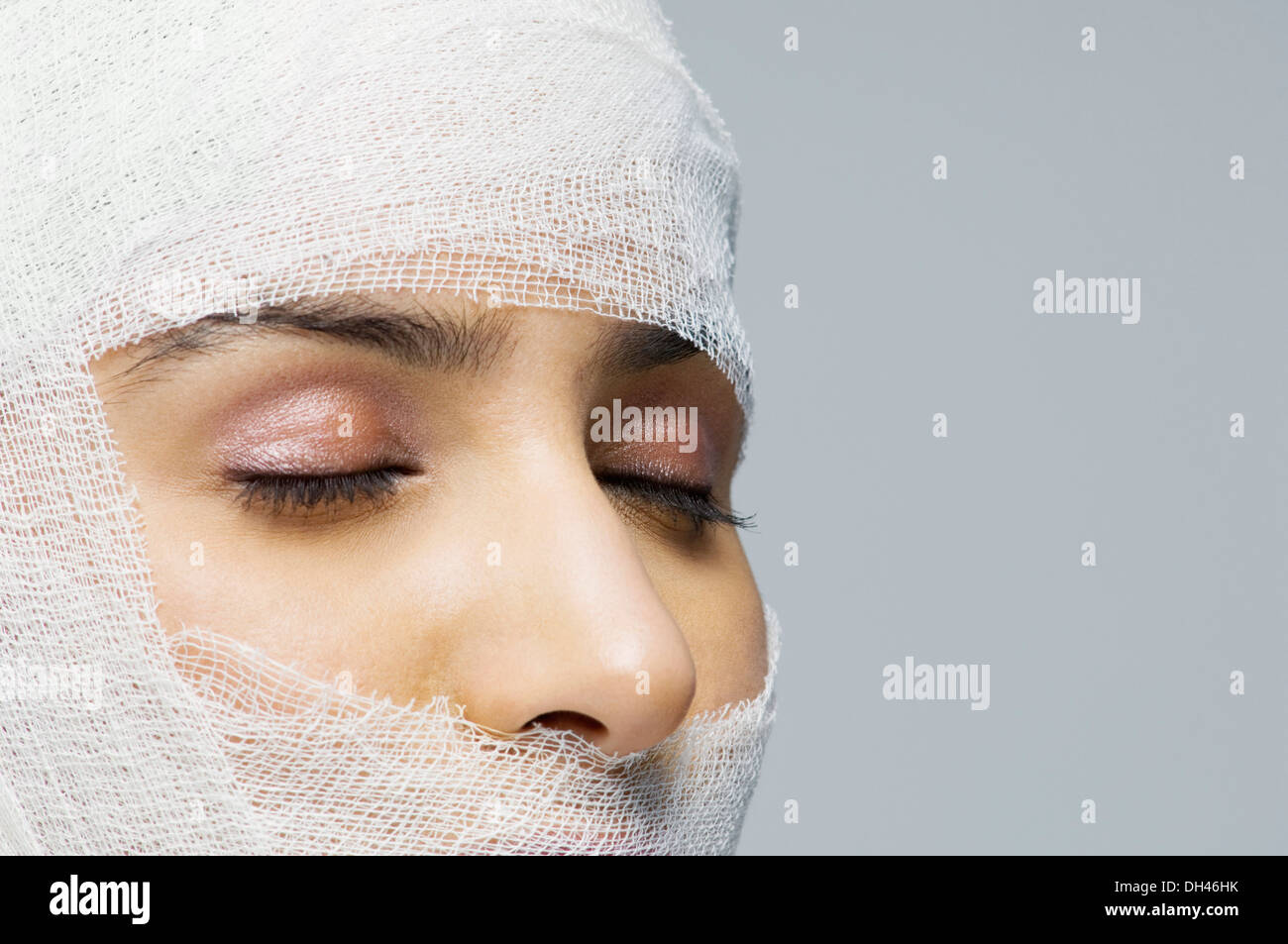Woman's face wrapped with a bandage Stock Photo - Alamy