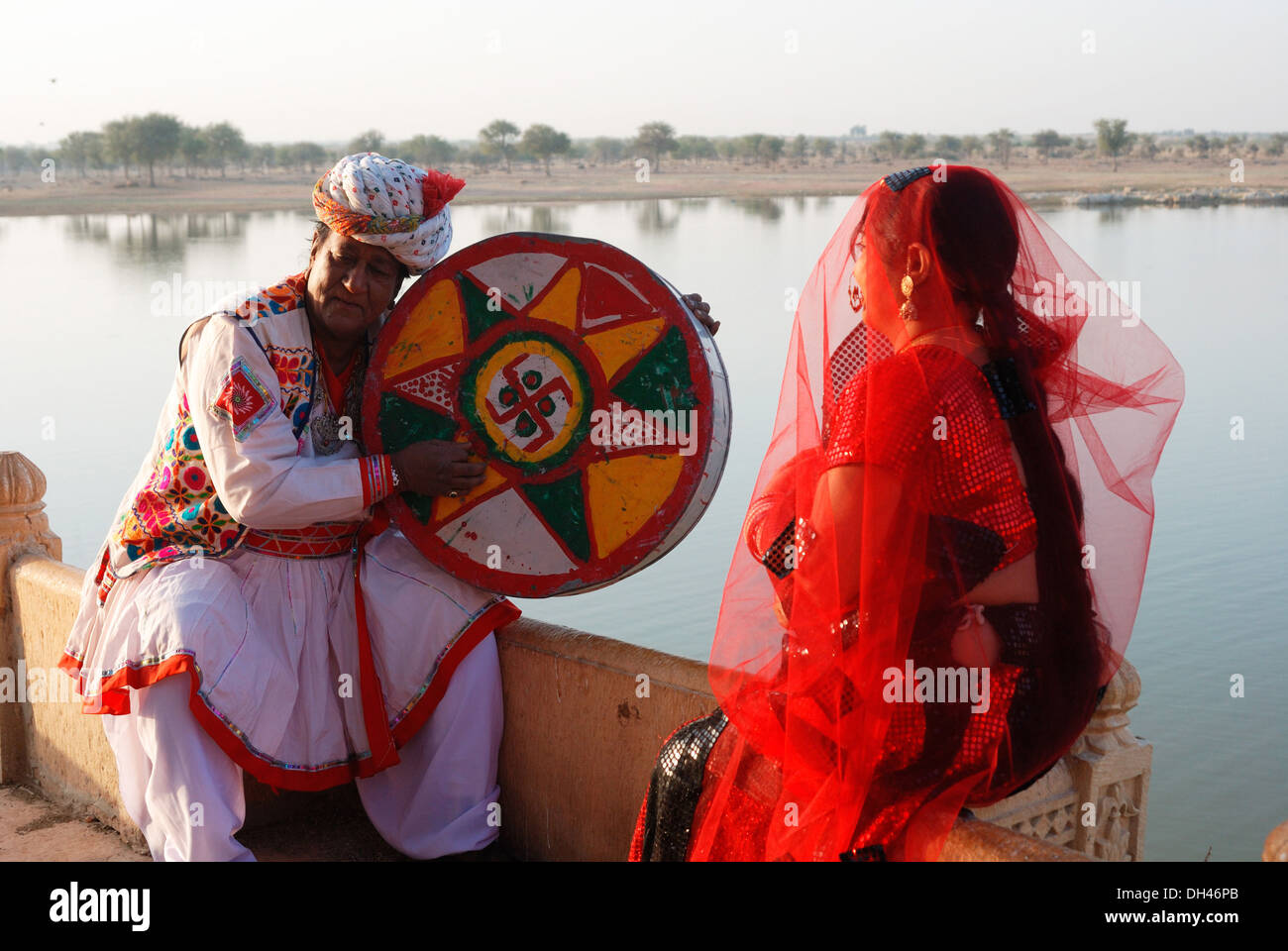 indian woman listening to man playing daphli musical instrument Gadisar ...