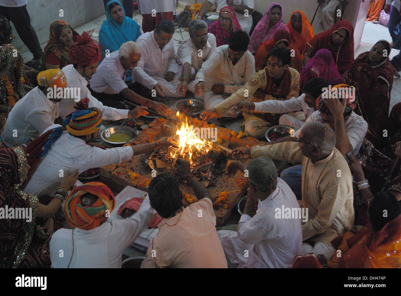 Several people performing Havan sitting around fire Jodhpur Rajasthan ...