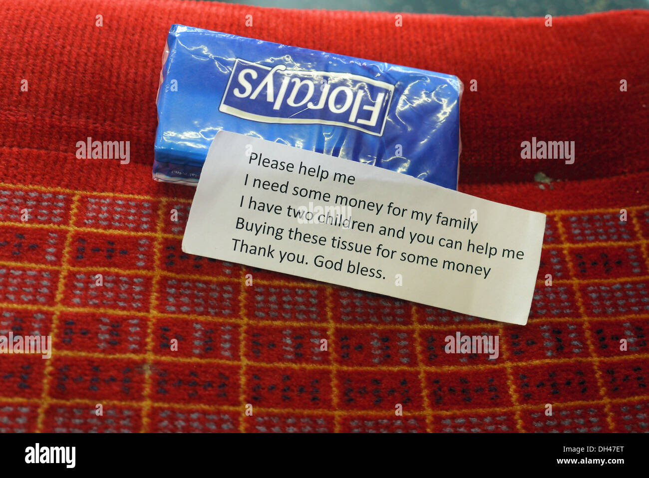 A small pocket-sized pack of tissues with a begging note asking ...