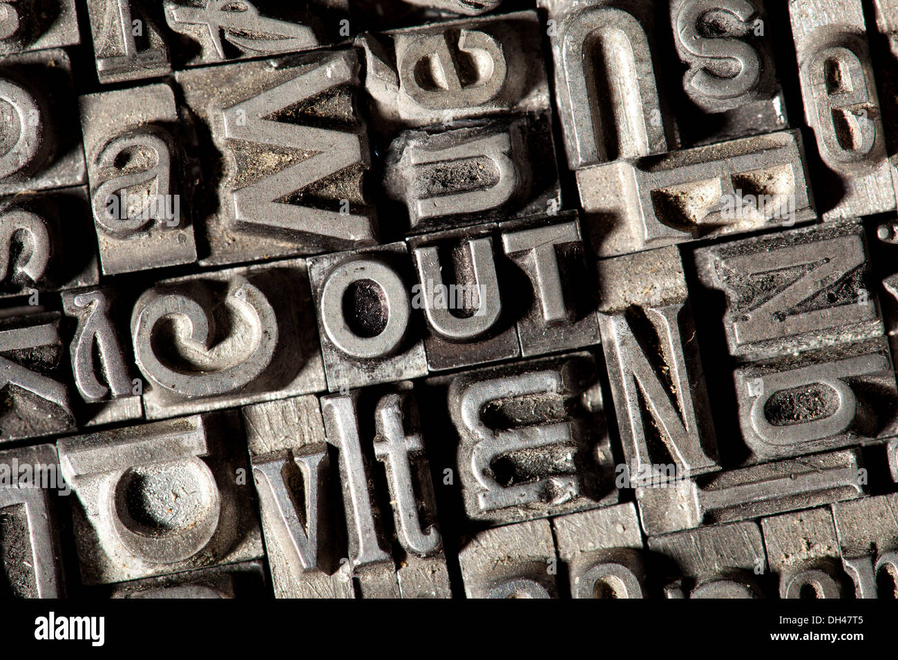 Old lead letters forming the word OUT Stock Photo - Alamy