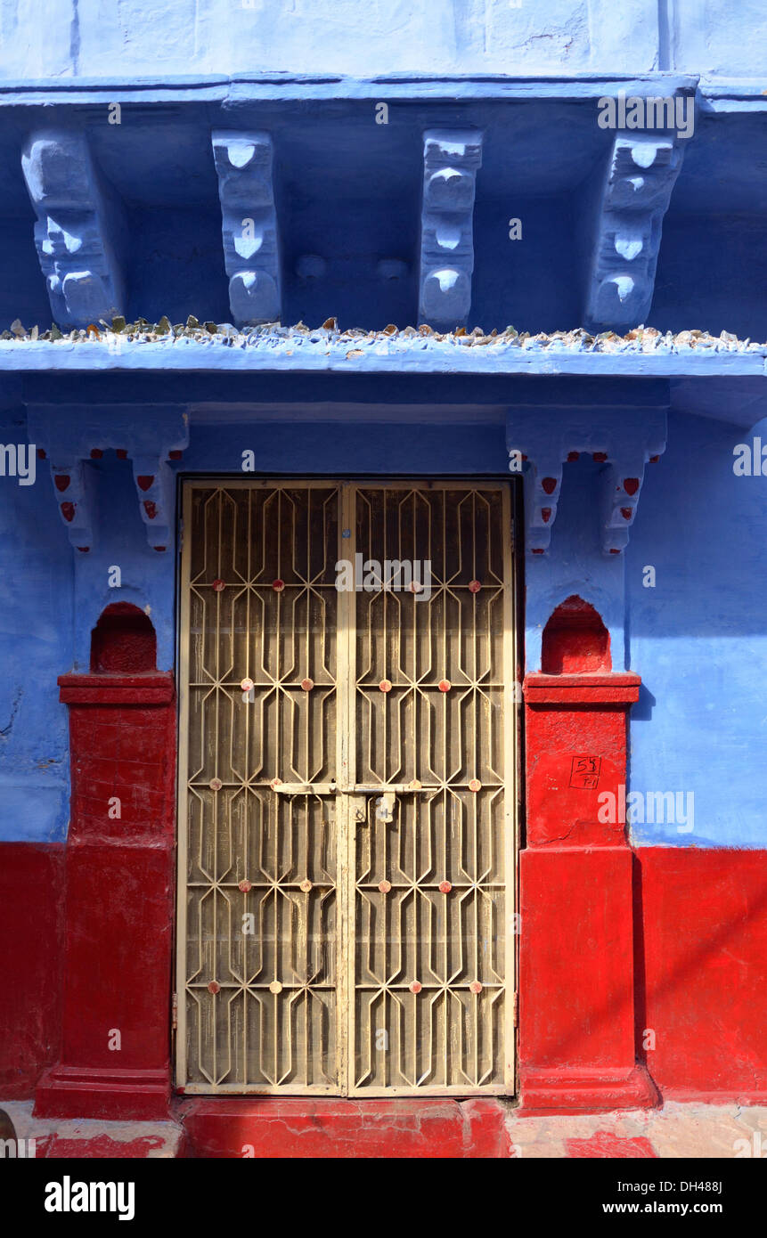House cream metal door blue walls red pillars alcove Jodhpur Rajasthan ...