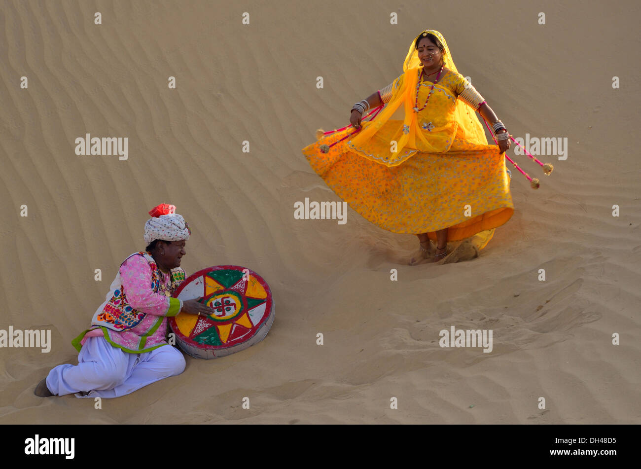 Indian man playing duff and woman dancing desert Rajasthan India Asia ...