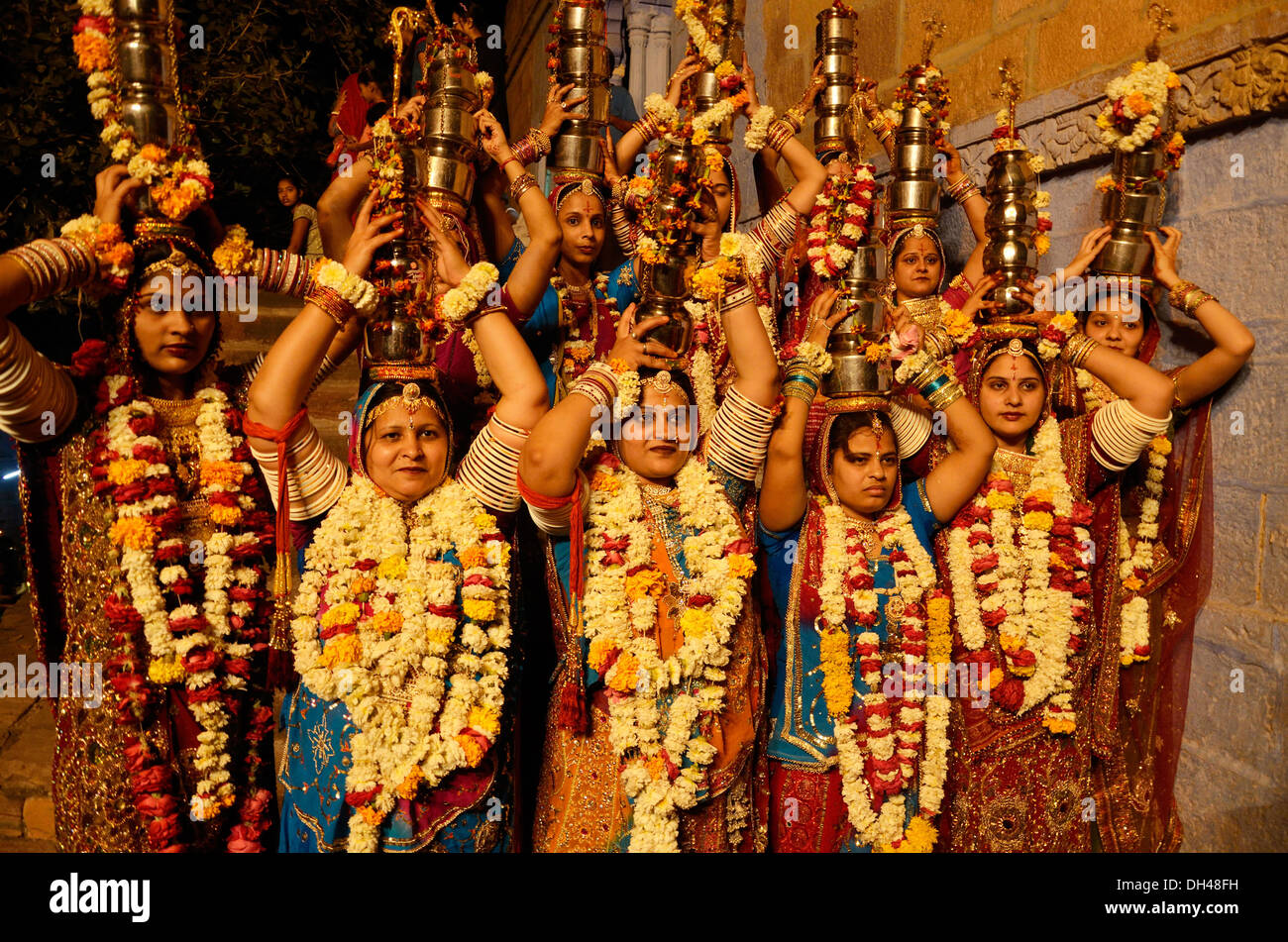 women wearing garlands holding pots kalash on heads festival Rajasthan ...