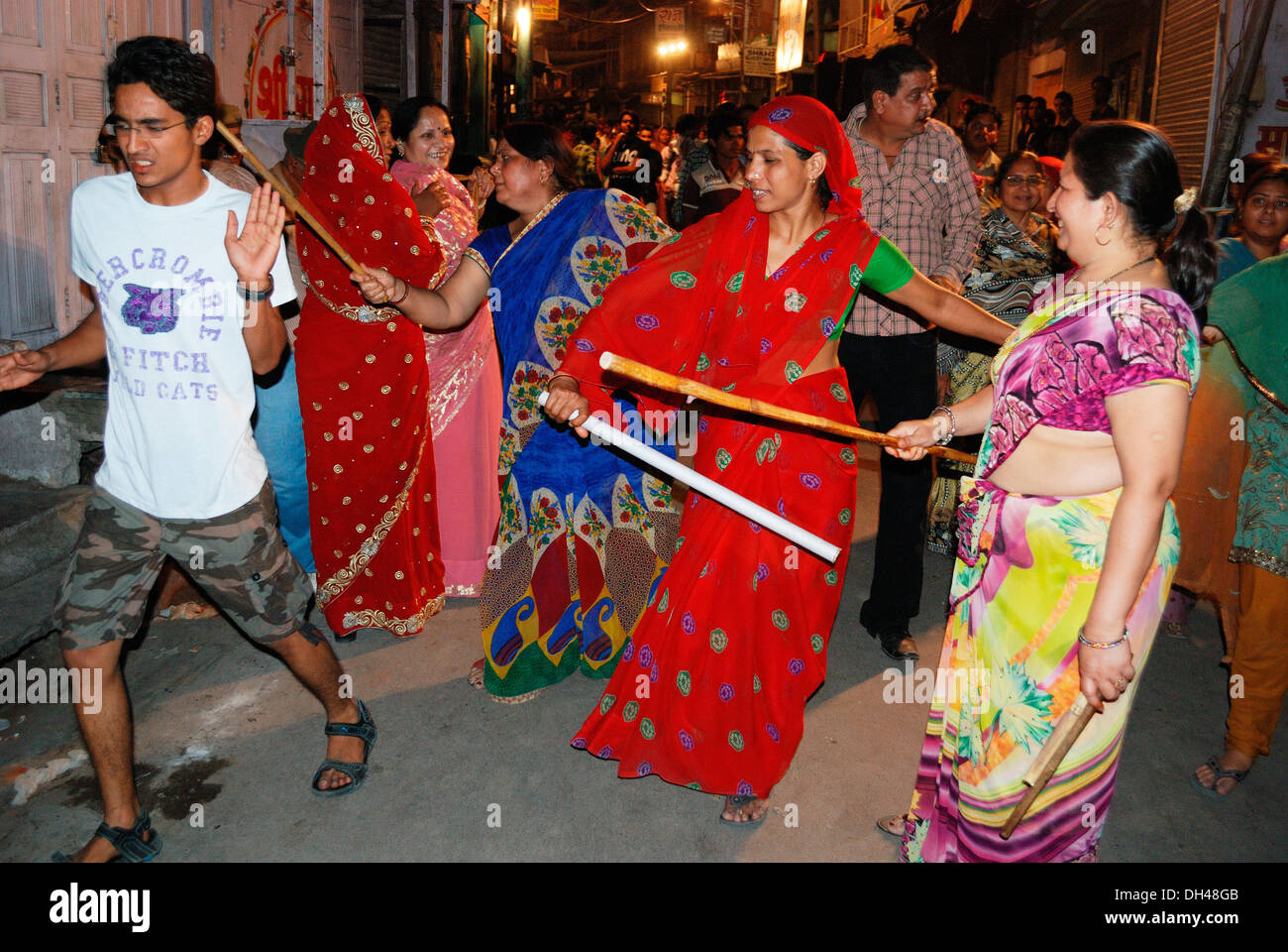 women beating boy with stick weird festival jodhpur Rajasthan India ...