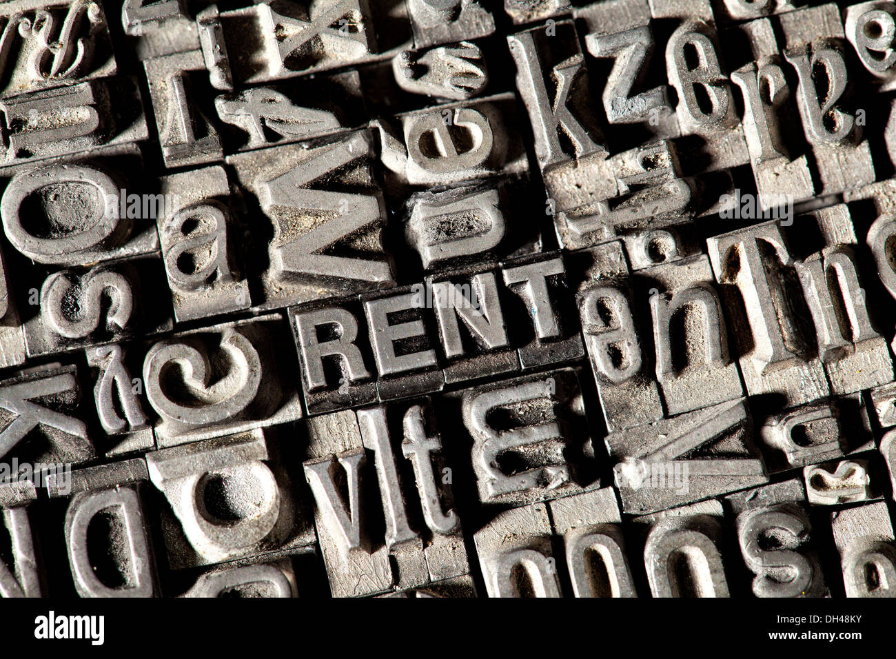 Old lead letters forming the word RENT Stock Photo - Alamy