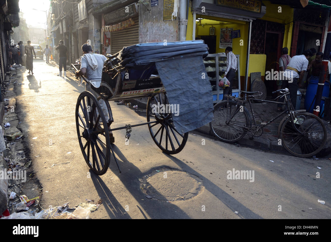 Hand pulling rickshaw puller pulling hi-res stock photography and ...